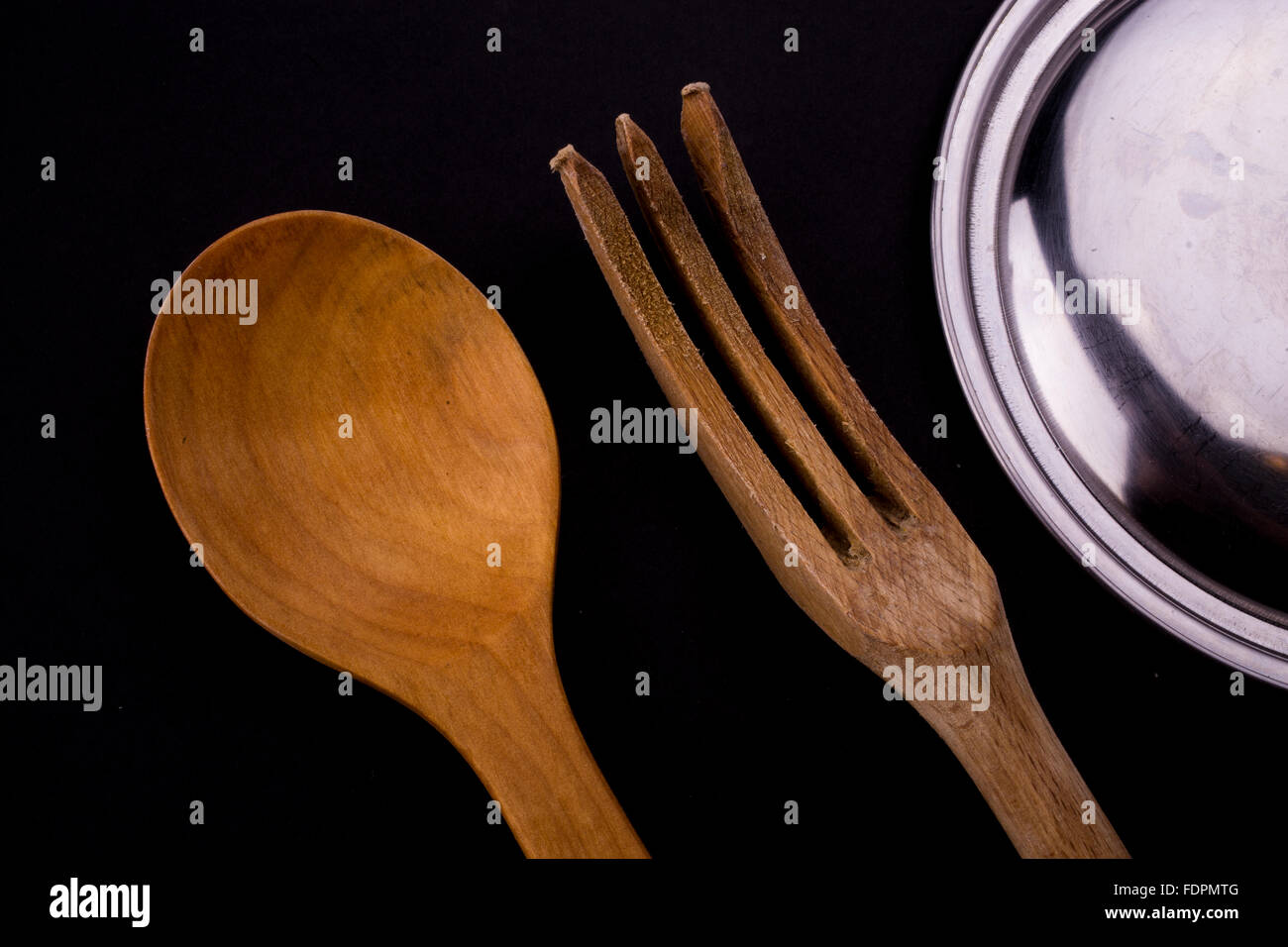 Still life of wooden carved cutlery isolated on black Stock Photo - Alamy