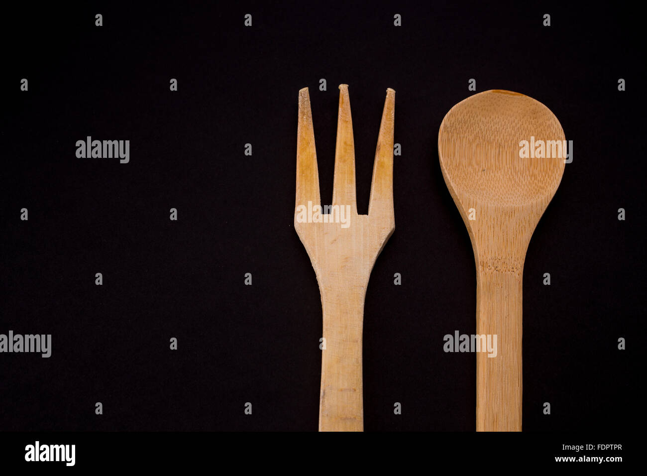 Still life of wooden carved cutlery isolated on black Stock Photo - Alamy
