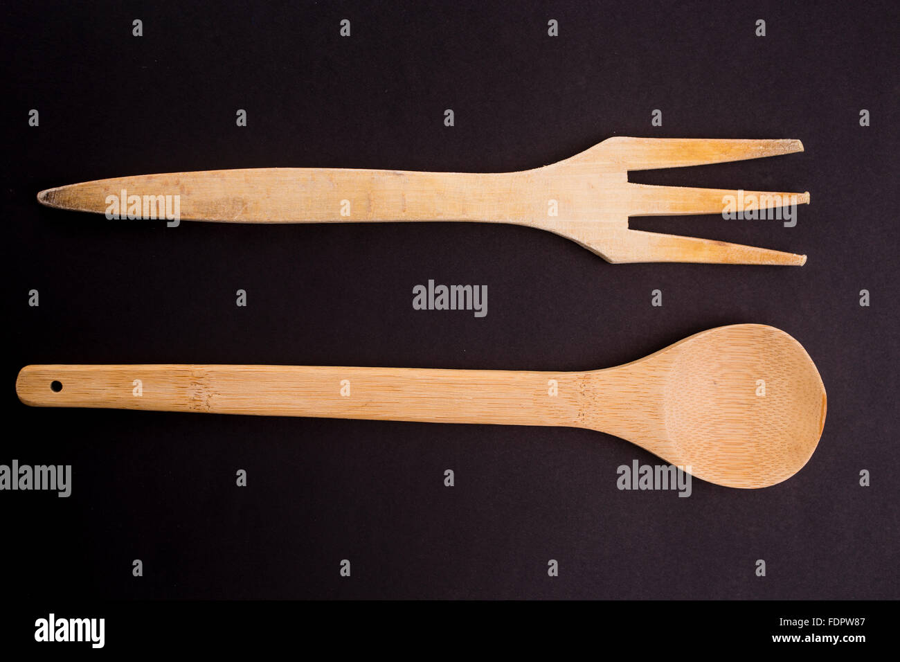 Still life of wooden carved cutlery isolated on black Stock Photo - Alamy
