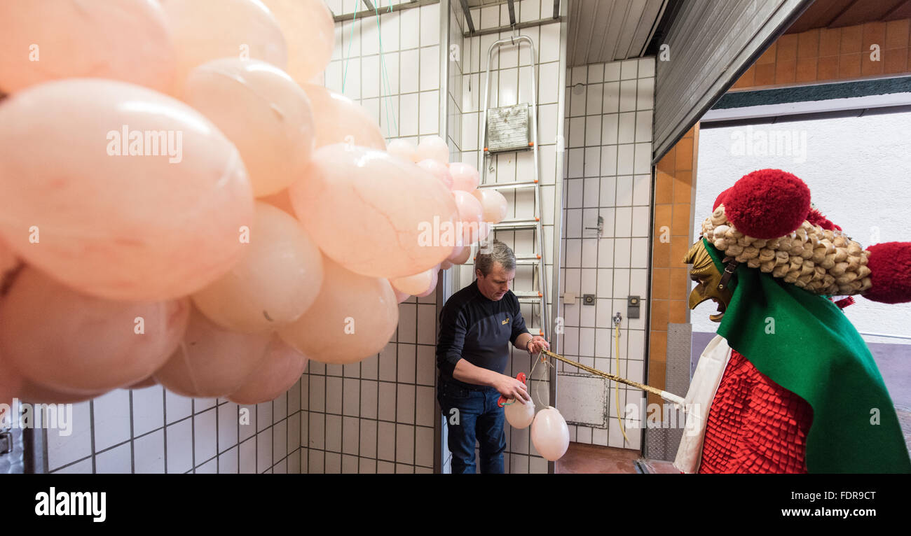A butcher filling a 'Saubloder', a pig bladder, with air, Elzach ...