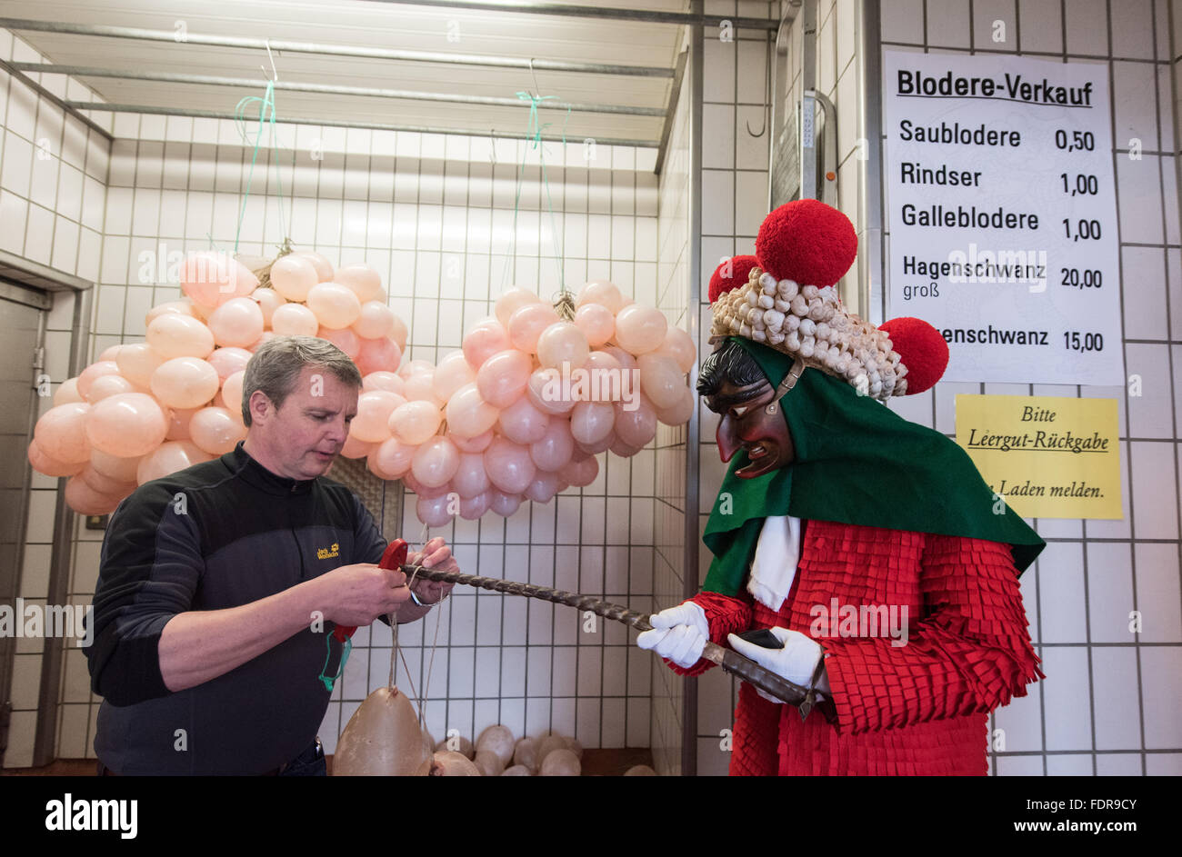 A butcher filling a 'Saubloder', a pig bladder, with air, Elzach ...