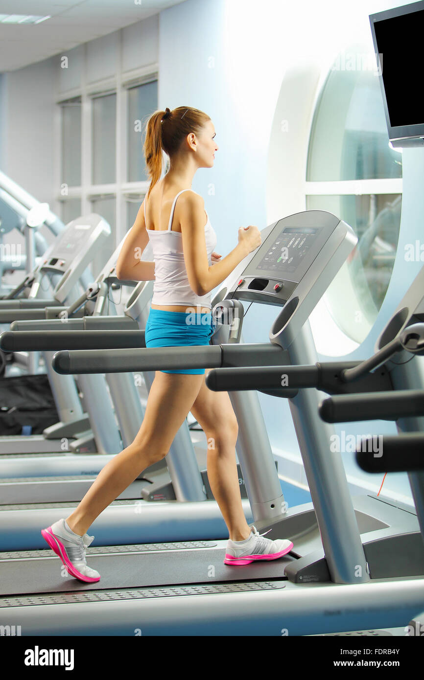 Image of fitness girl running on treadmill Stock Photo - Alamy
