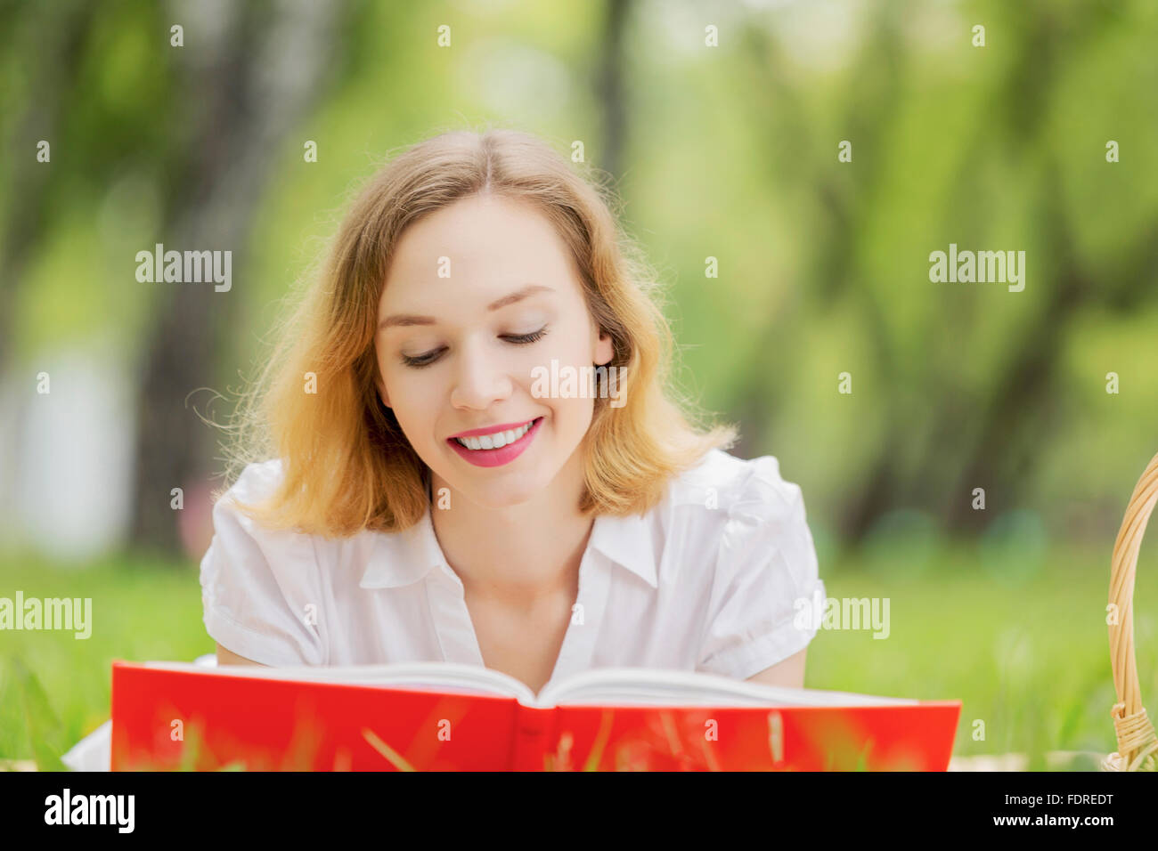 Young pretty woman in summer park reading book Stock Photo - Alamy