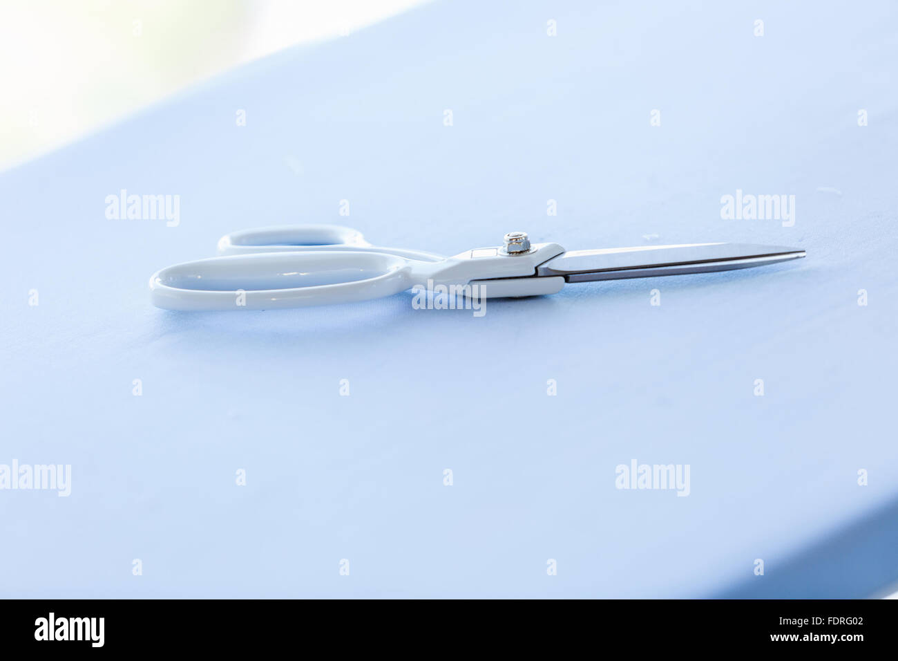 Close up of scissors lying on table Stock Photo - Alamy