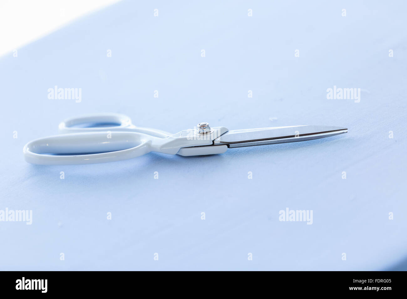 Close up of scissors lying on table Stock Photo - Alamy