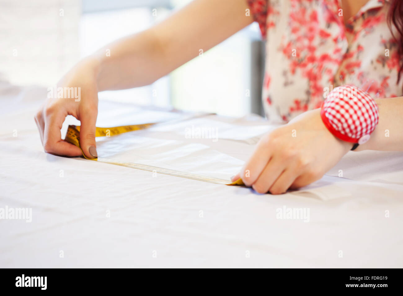 close up of dressmaker at work making patterns of fabric Stock Photo ...
