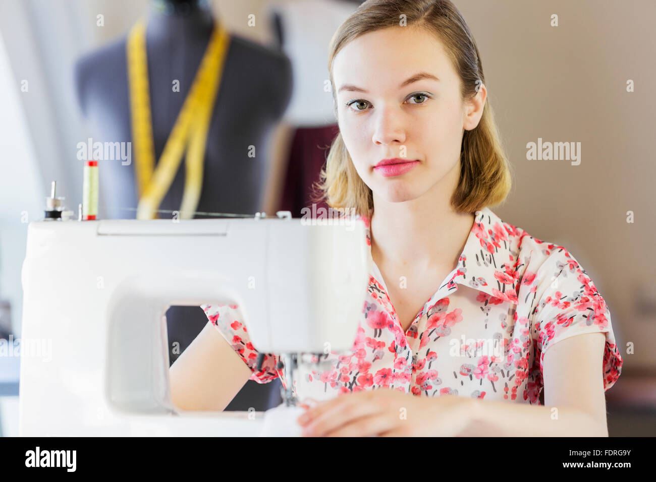 Young attractive woman dressmaker working with sewing machine Stock ...
