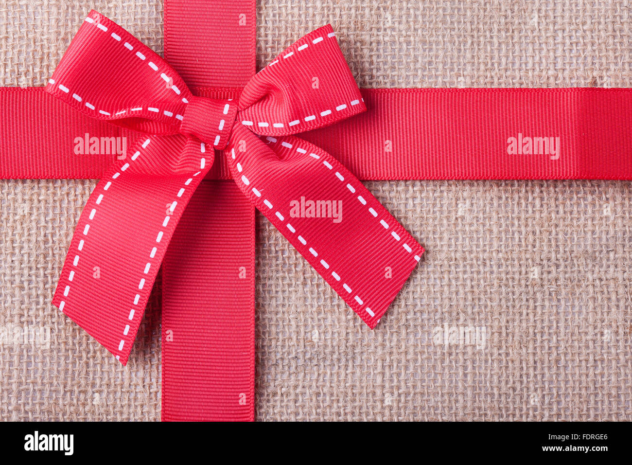red gift ribbon on cloth background closeup Stock Photo - Alamy