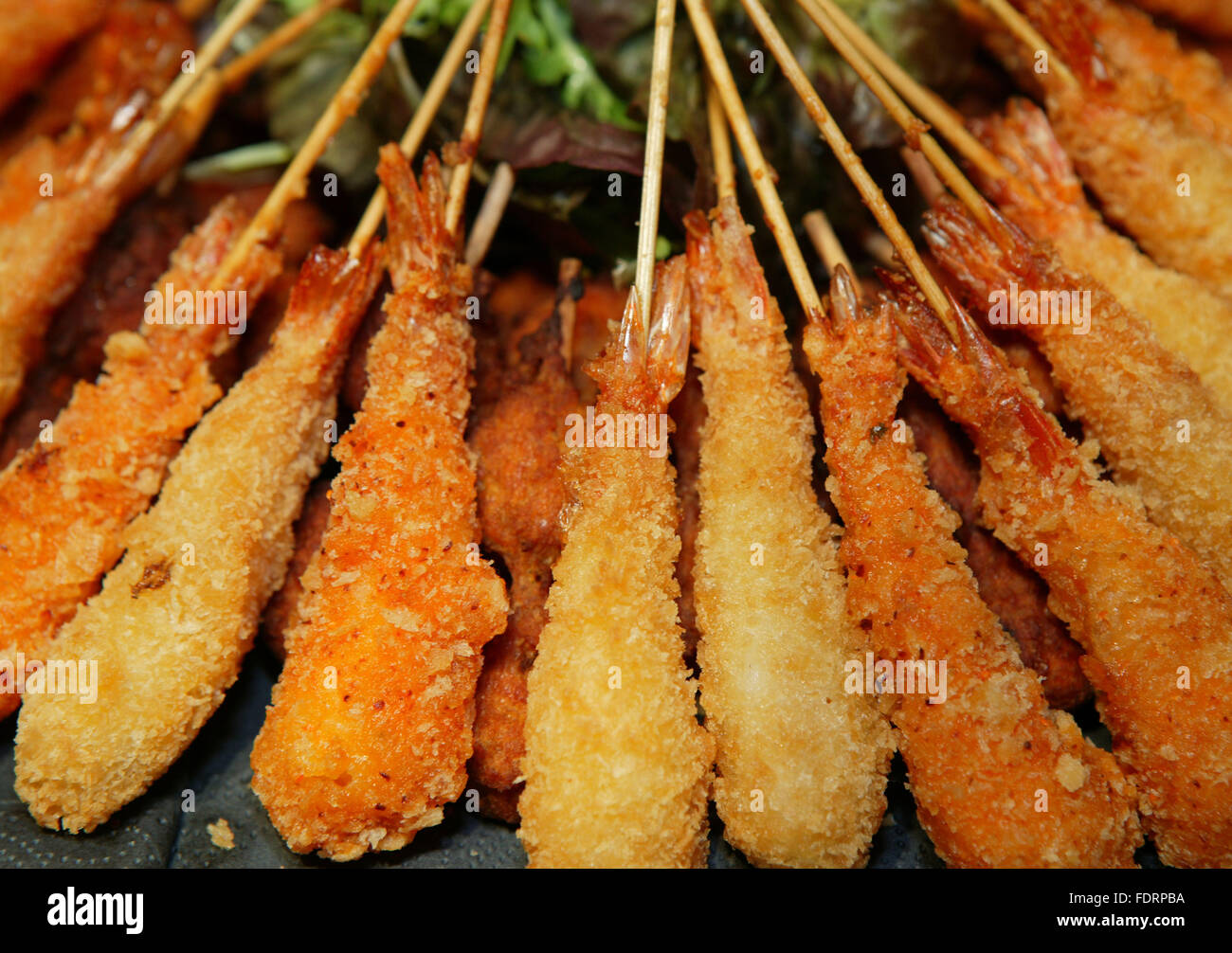 Prawns coated with breadcrumbs on sticks Stock Photo - Alamy