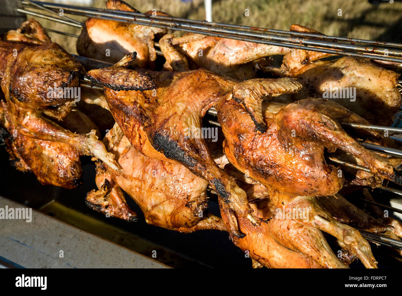 Chickens on a spit roast Stock Photo - Alamy