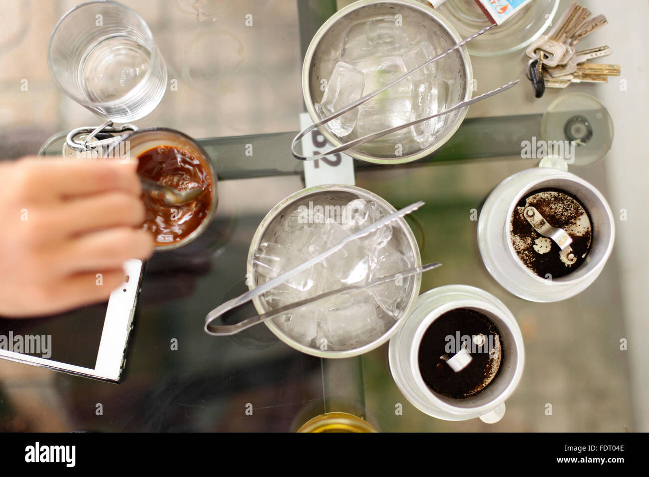 Hand stiring a white cup of Coffee on wood table Stock Photo - Alamy