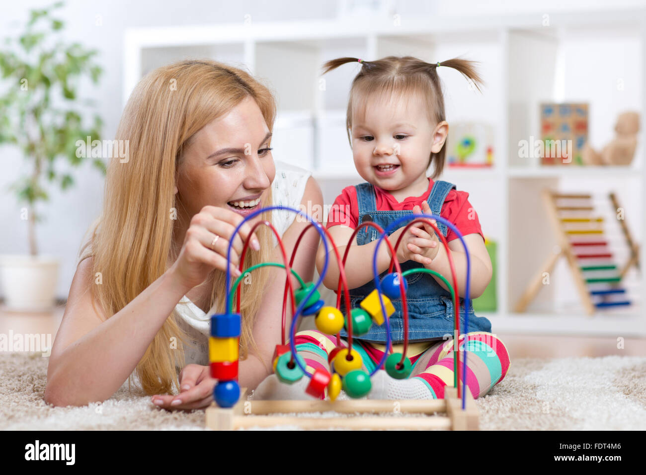 happy kid girl and mom playing toy Stock Photo - Alamy