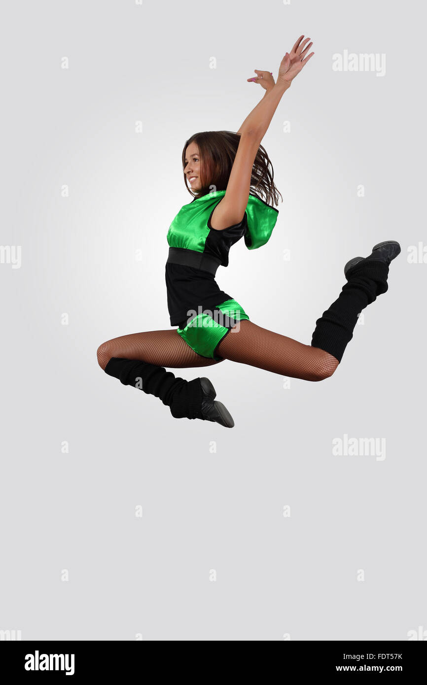Young female dancer jumping against white background Stock Photo - Alamy