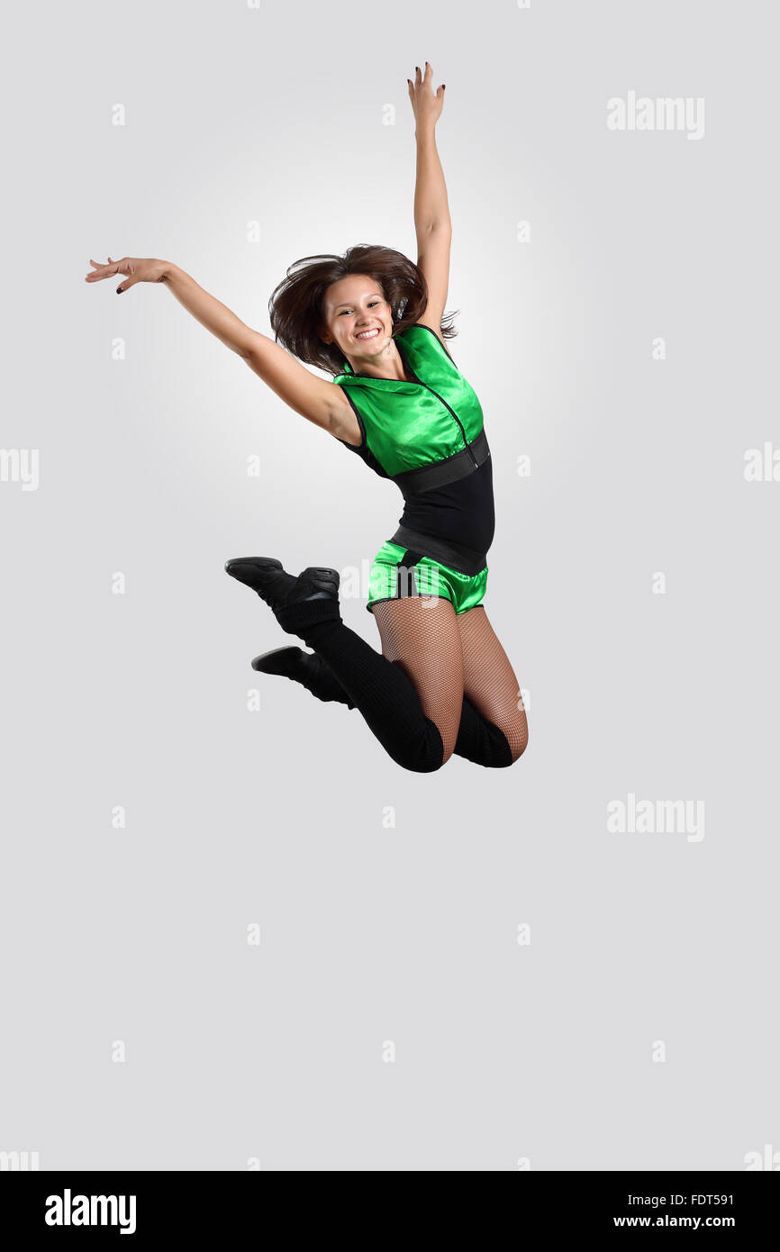 Young female dancer jumping against white background Stock Photo - Alamy
