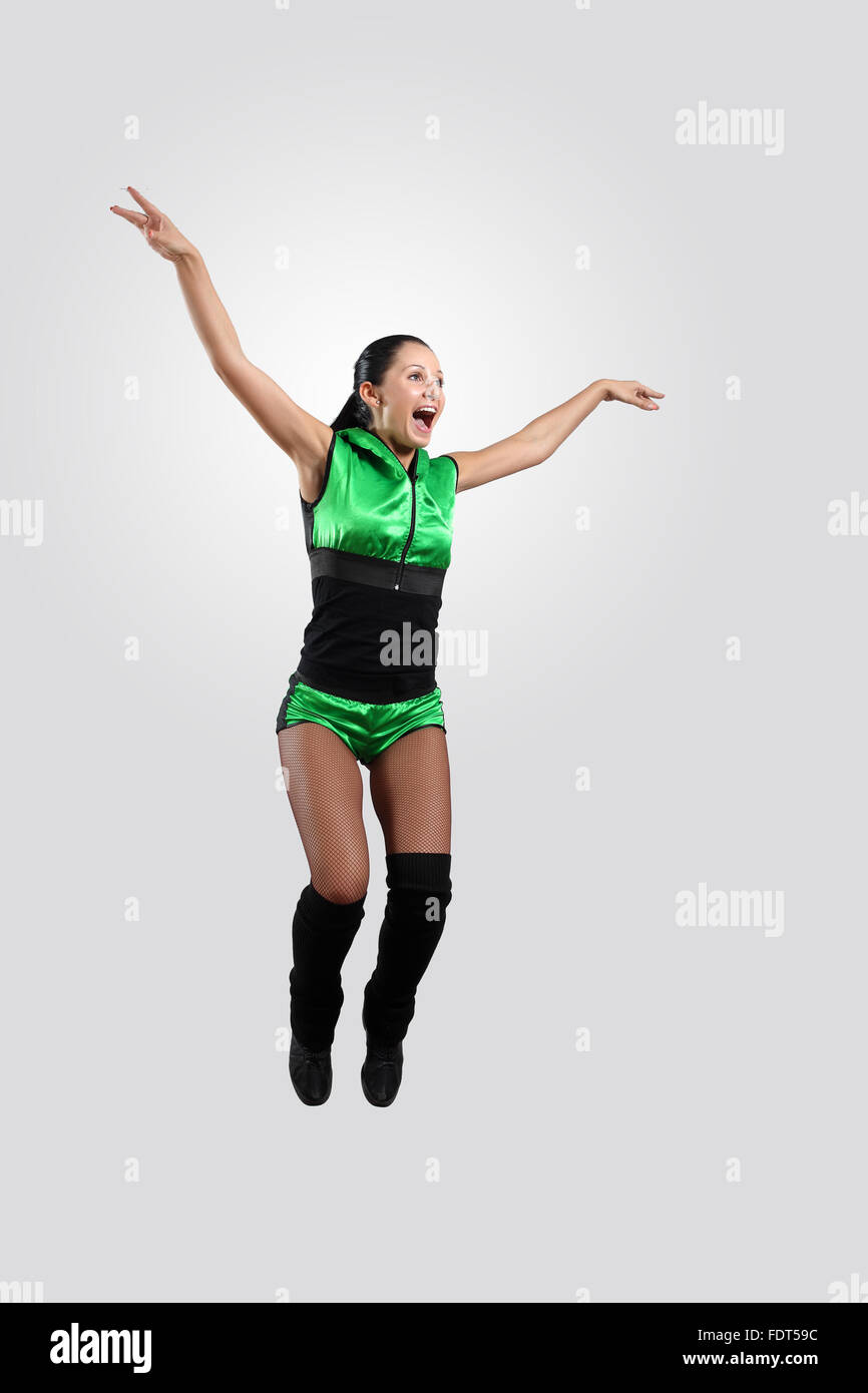 Young female dancer jumping against white background Stock Photo - Alamy