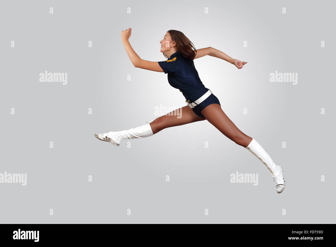 Young female dancer jumping against white background Stock Photo - Alamy