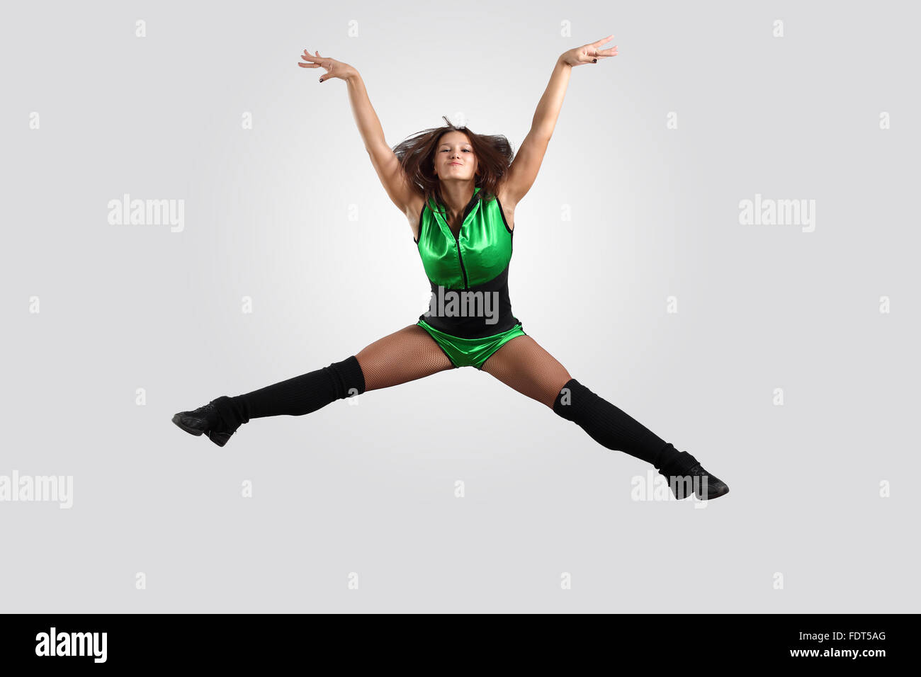 Young female dancer jumping against white background Stock Photo - Alamy