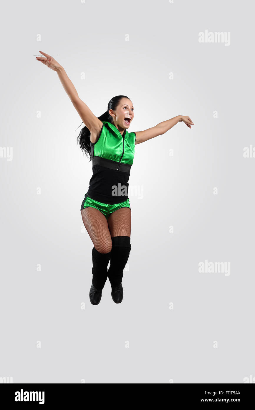 Young female dancer jumping against white background Stock Photo - Alamy