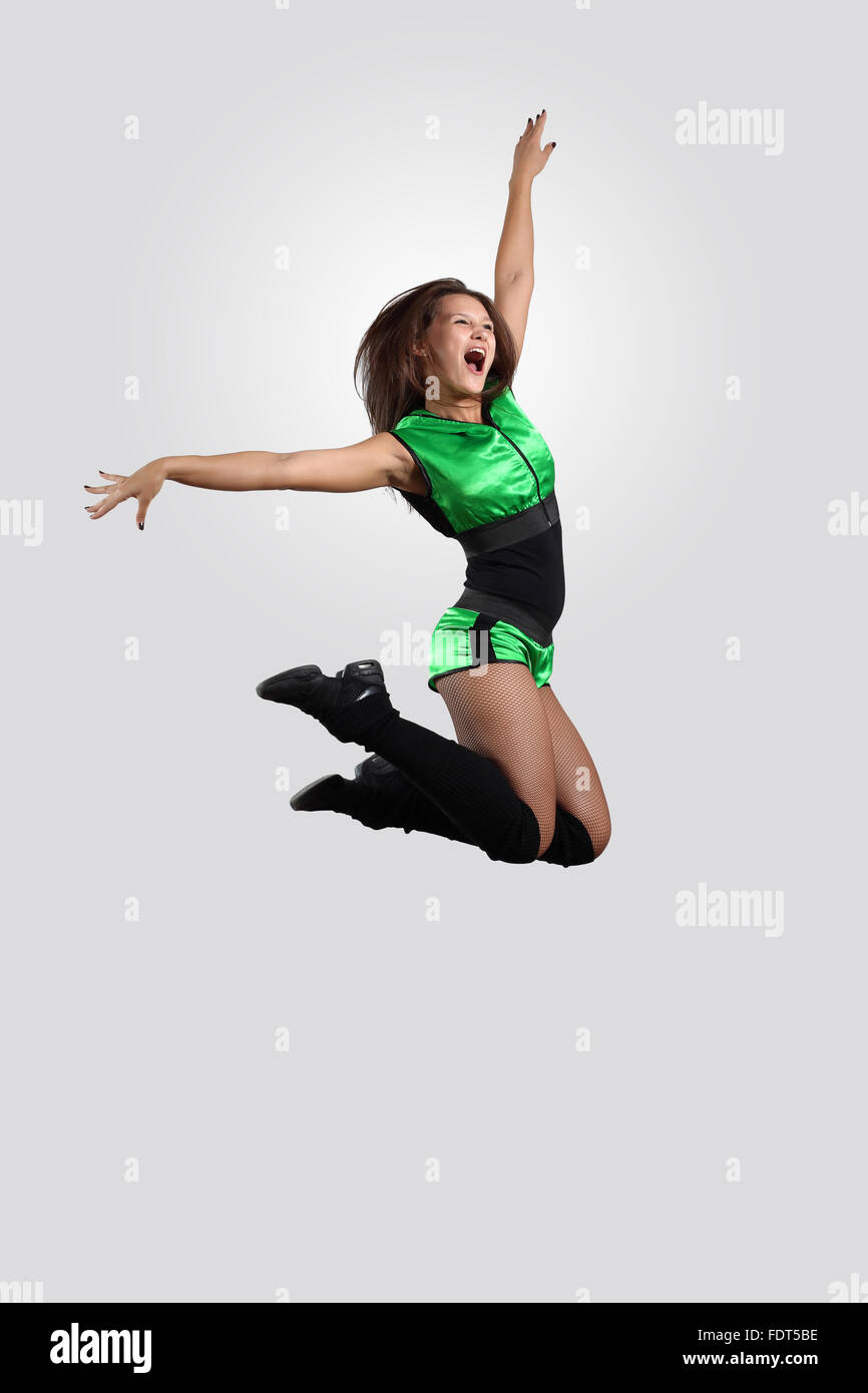 Young female dancer jumping against white background Stock Photo - Alamy