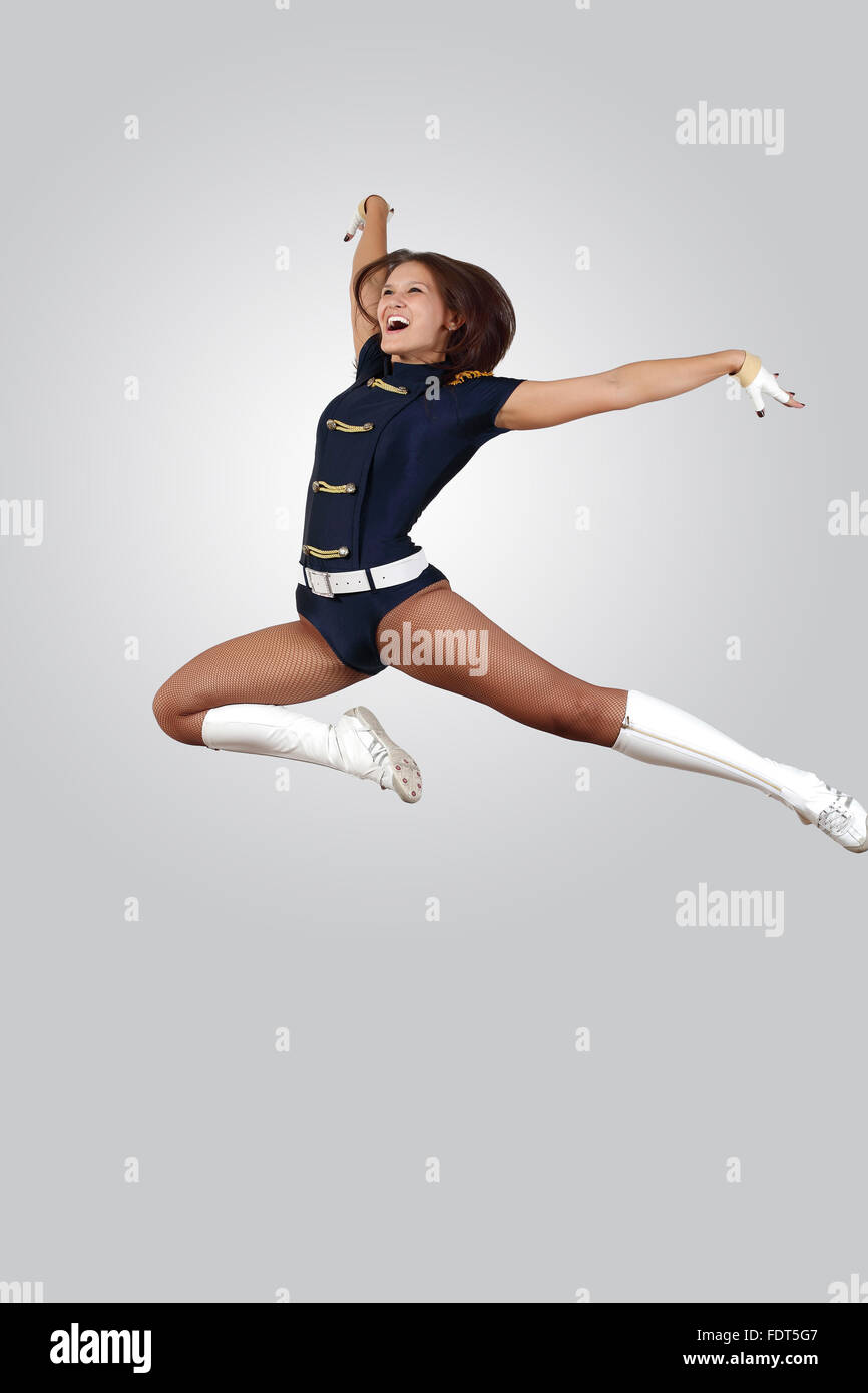 Young female dancer jumping against white background Stock Photo - Alamy
