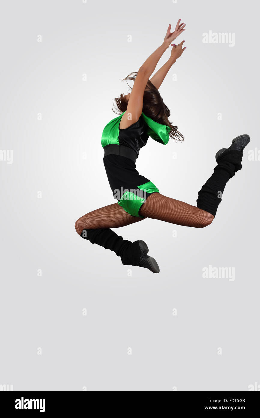 Young female dancer jumping against white background Stock Photo - Alamy