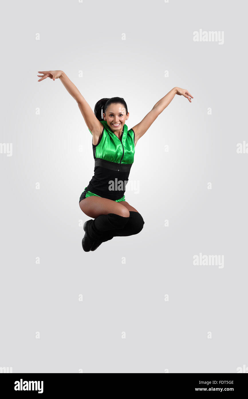 Young female dancer jumping against white background Stock Photo - Alamy