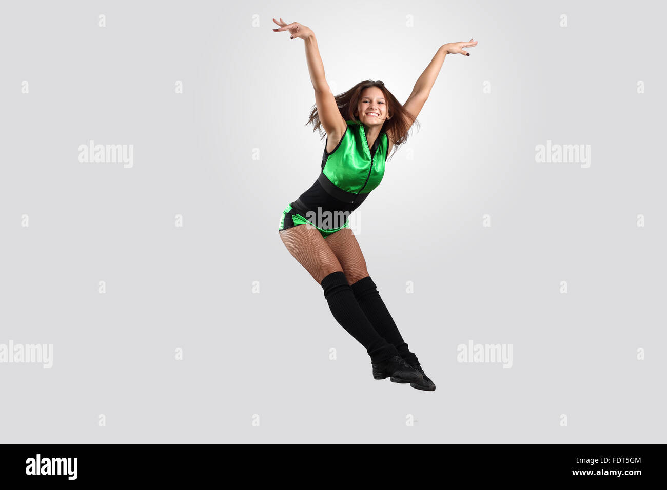 Young female dancer jumping against white background Stock Photo - Alamy