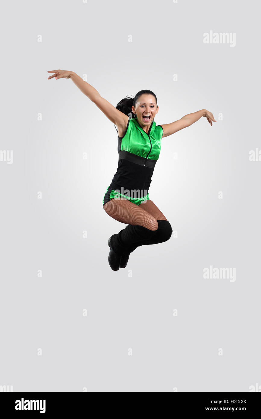 Young female dancer jumping against white background Stock Photo - Alamy