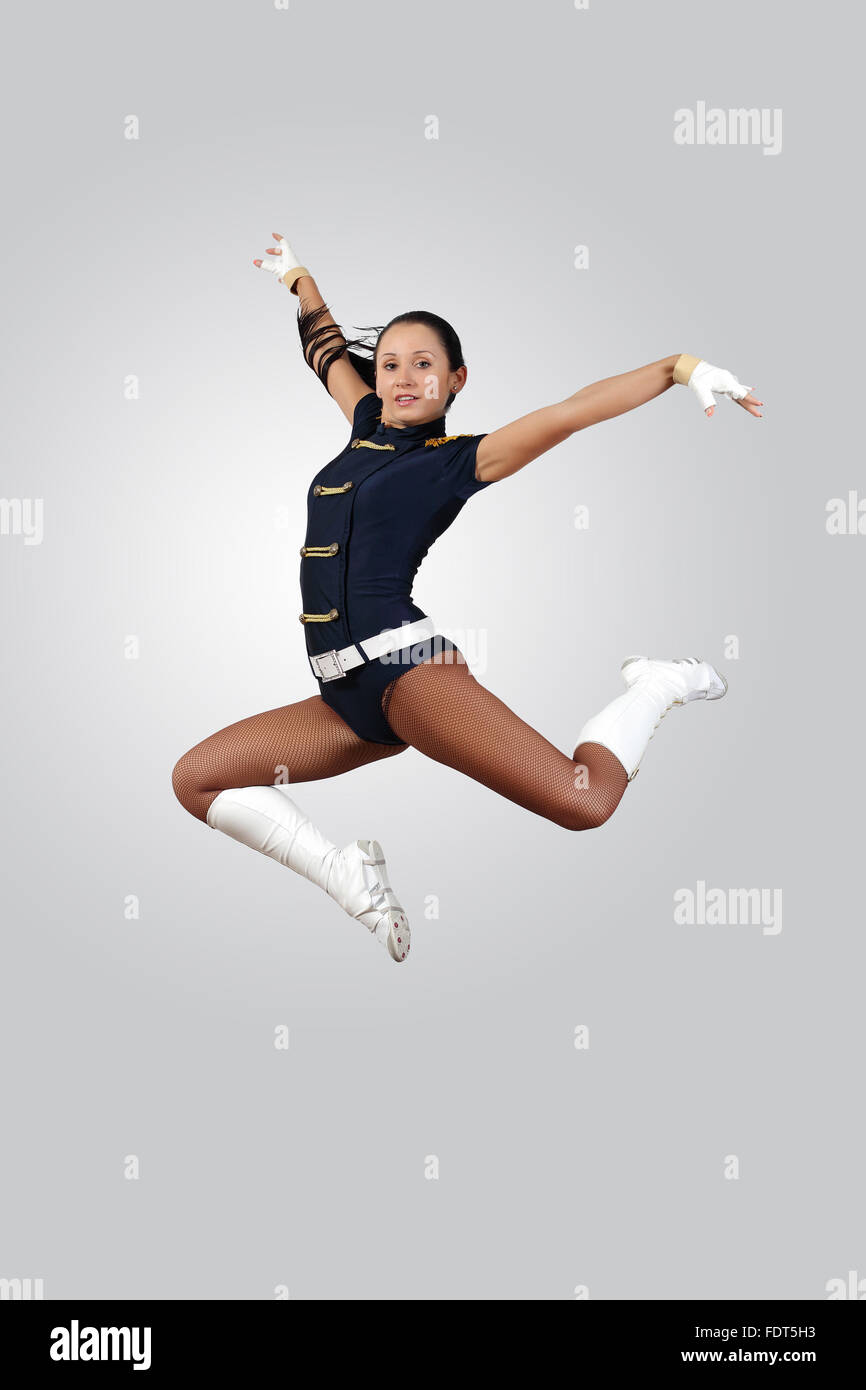 Young female dancer jumping against white background Stock Photo - Alamy