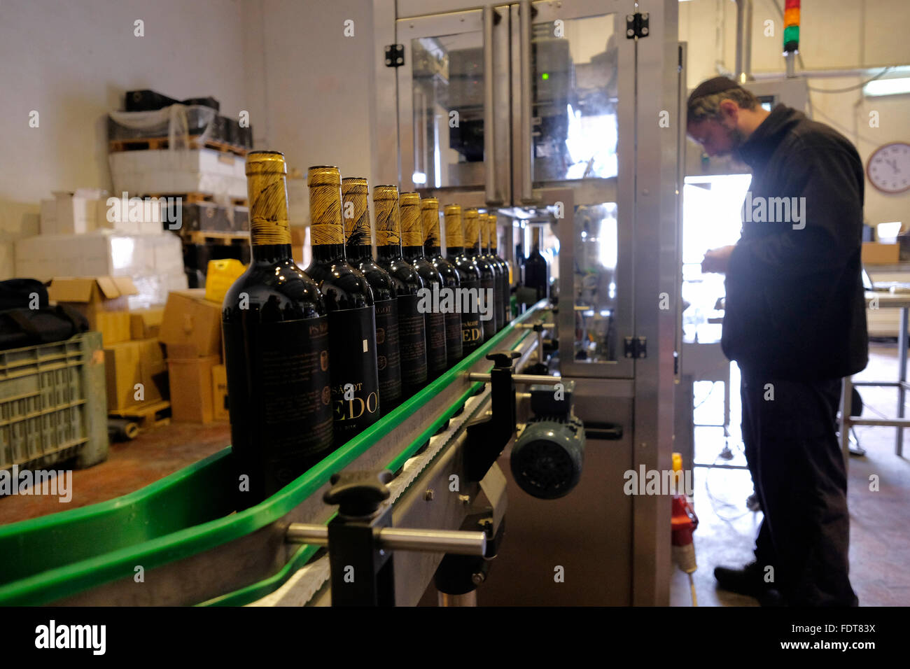 A Jewish settler works at the bottling line of Psagot winery located on ...