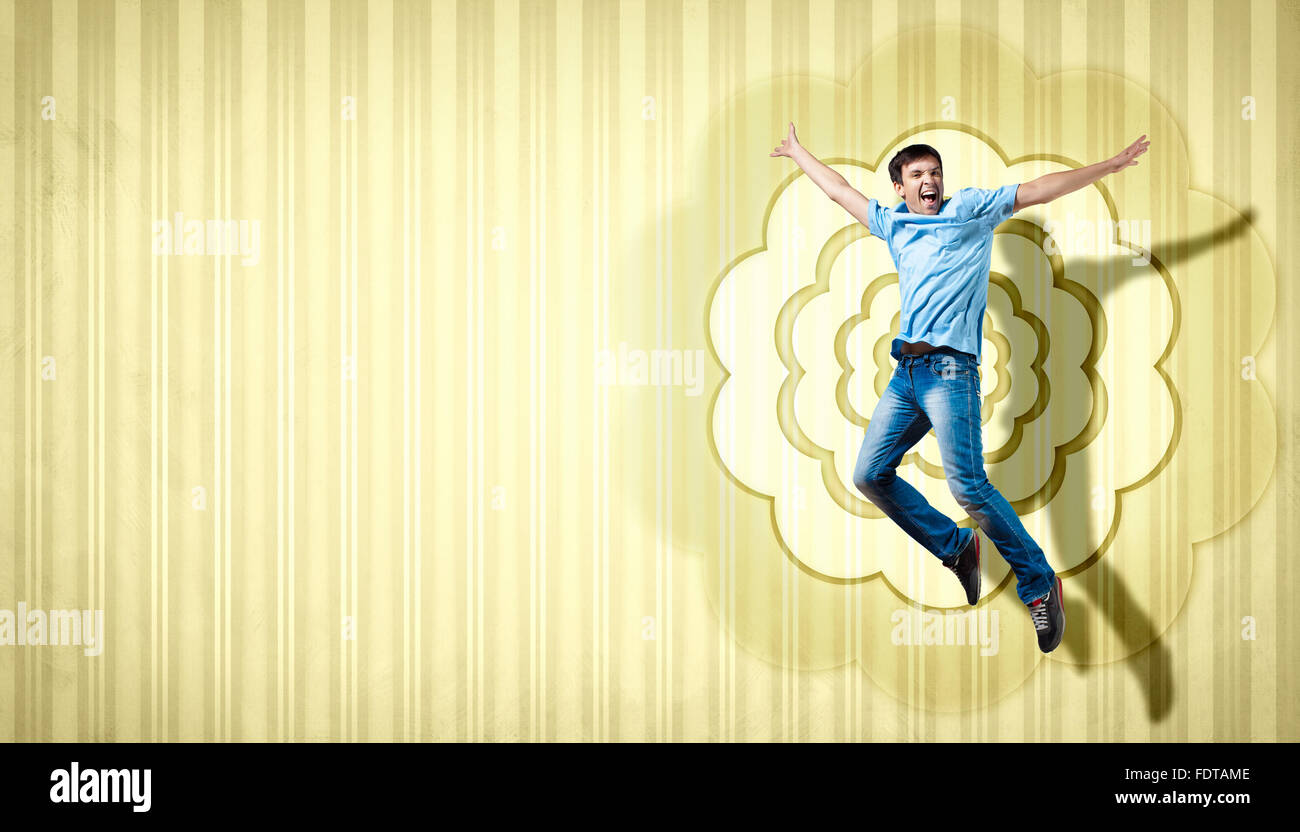 pretty modern slim hip-hop style man jumping dancing on a colour ...
