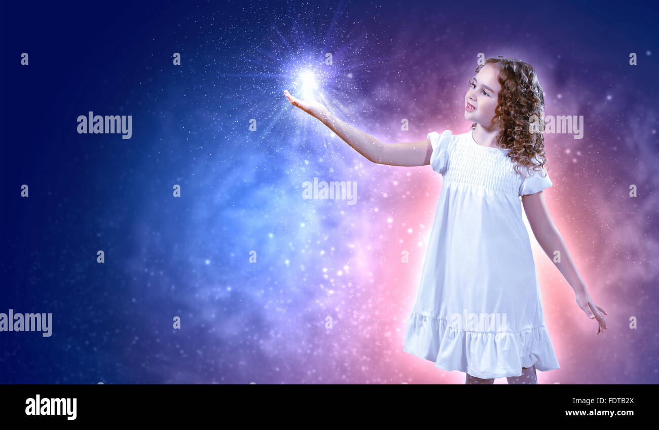 Little girl with magic lights and shining around Stock Photo - Alamy