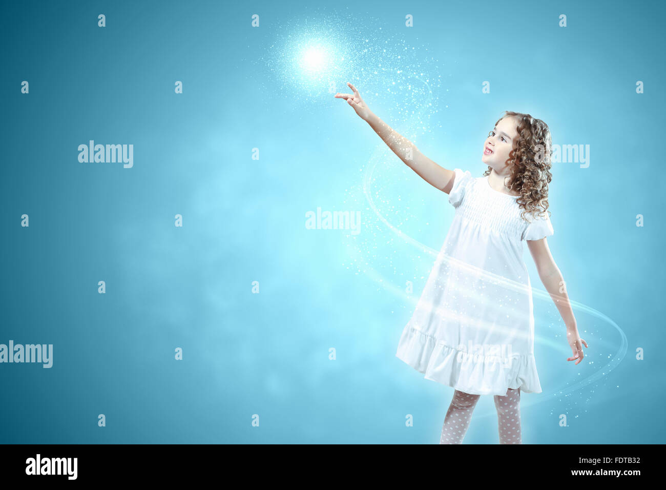 Little girl with magic lights and shining around Stock Photo - Alamy