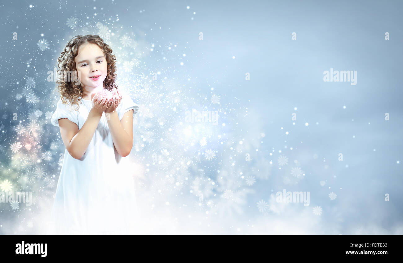 Little girl with magic lights and shining around Stock Photo - Alamy