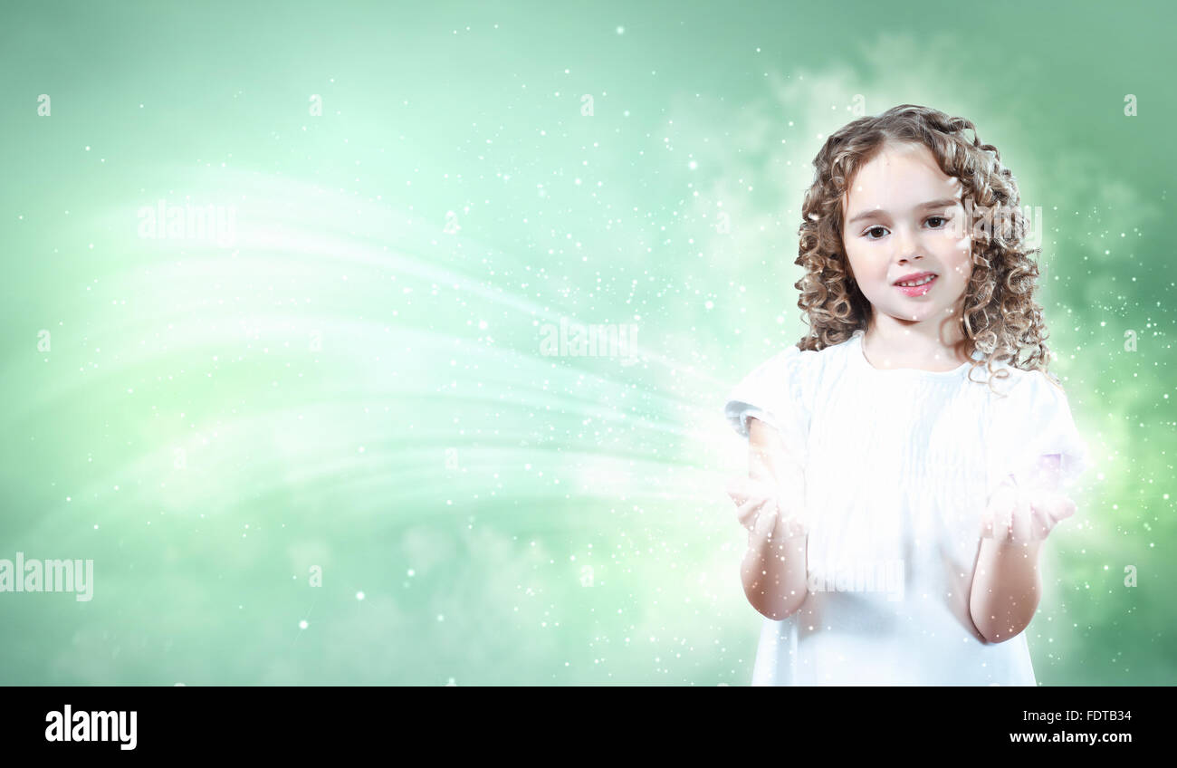 Little girl with magic lights and shining around Stock Photo - Alamy