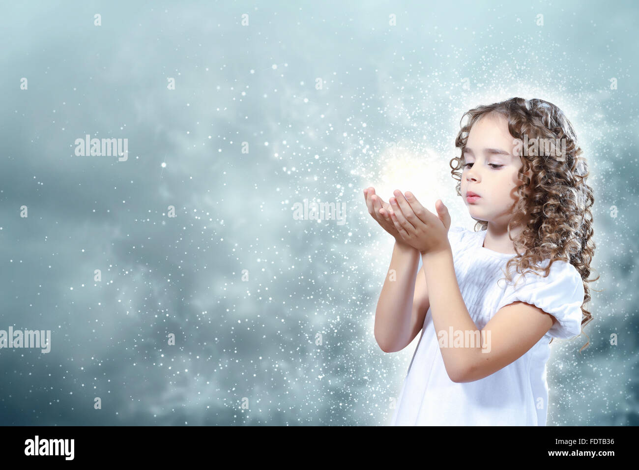 Little girl with magic lights and shining around Stock Photo - Alamy