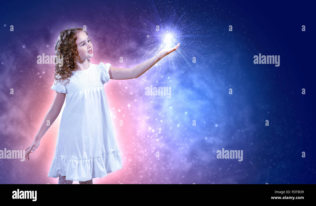 Little girl with magic lights and shining around Stock Photo - Alamy