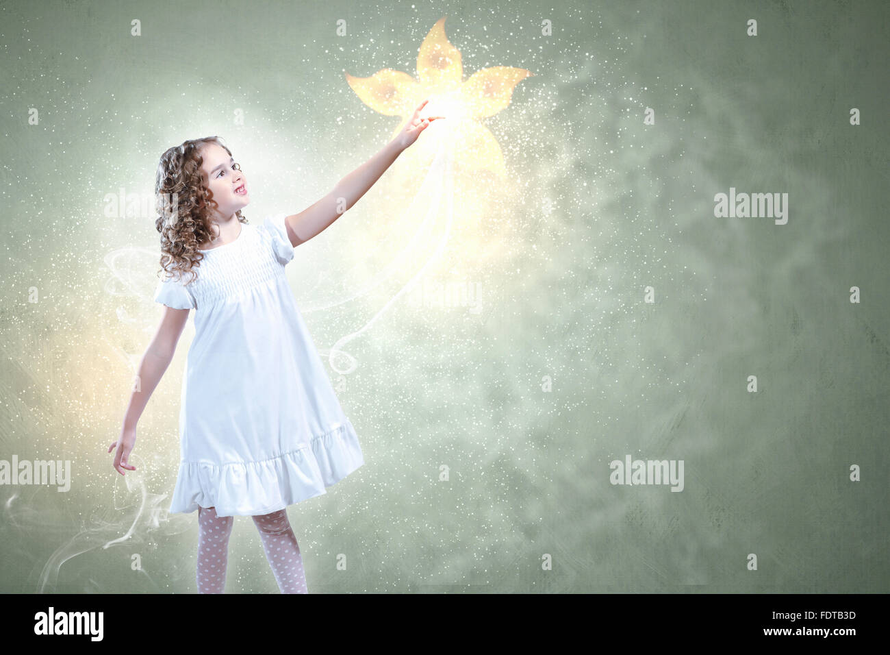 Little girl with magic lights and shining around Stock Photo - Alamy