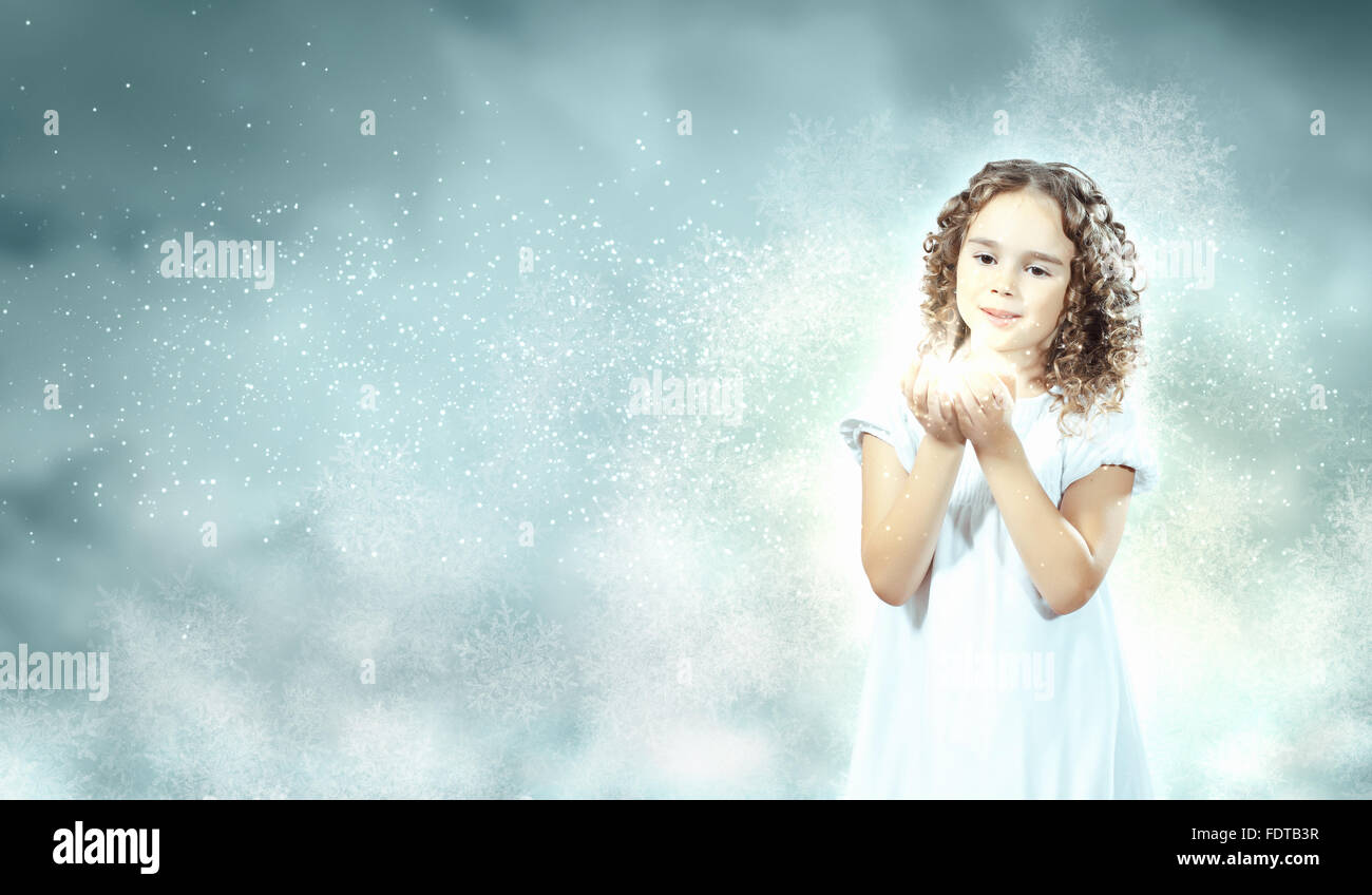 Little girl with magic lights and shining around Stock Photo - Alamy