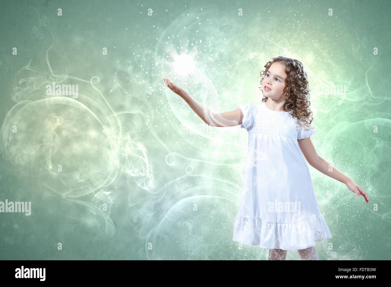 Little girl with magic lights and shining around Stock Photo - Alamy