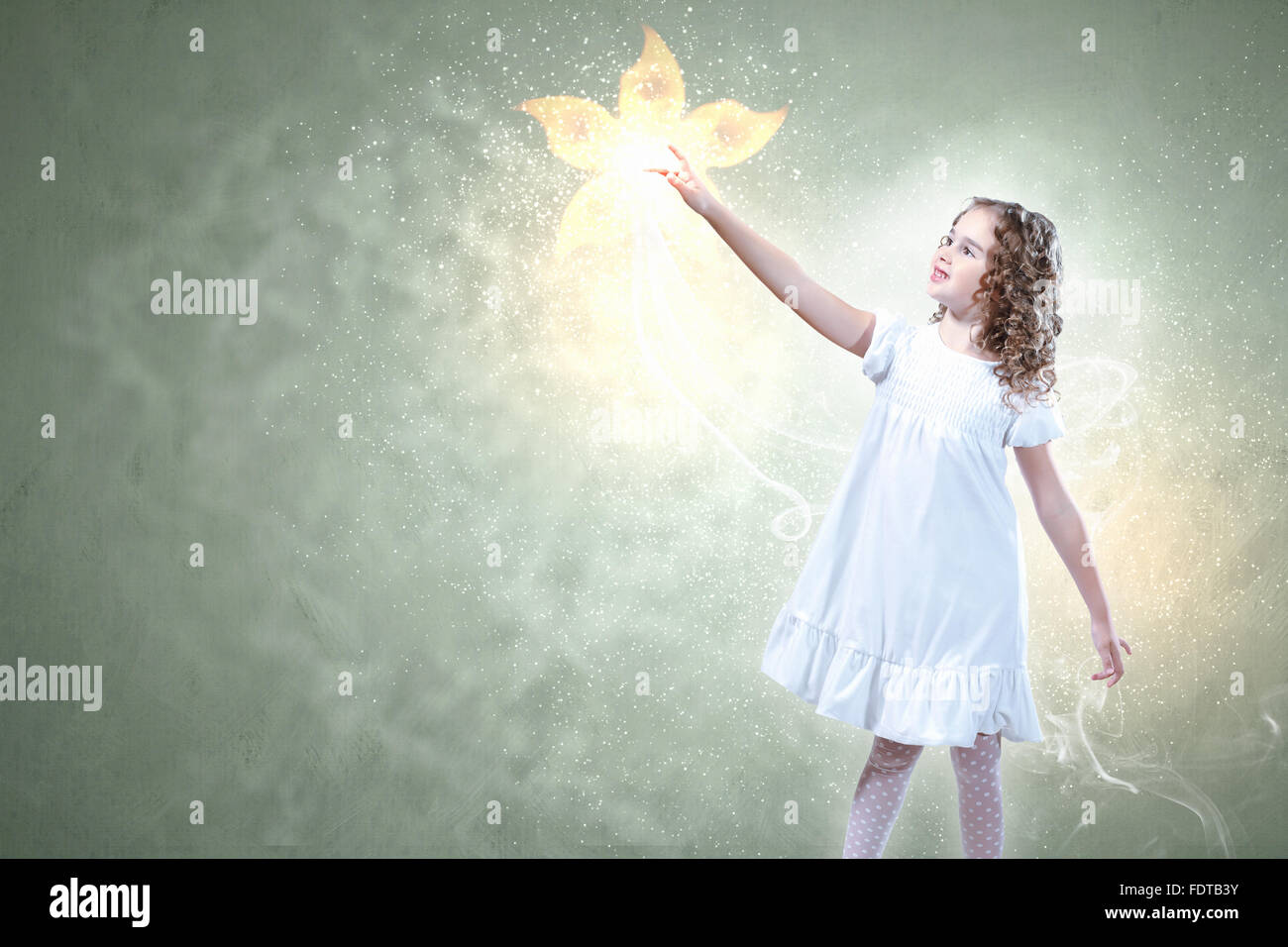 Little girl with magic lights and shining around Stock Photo - Alamy