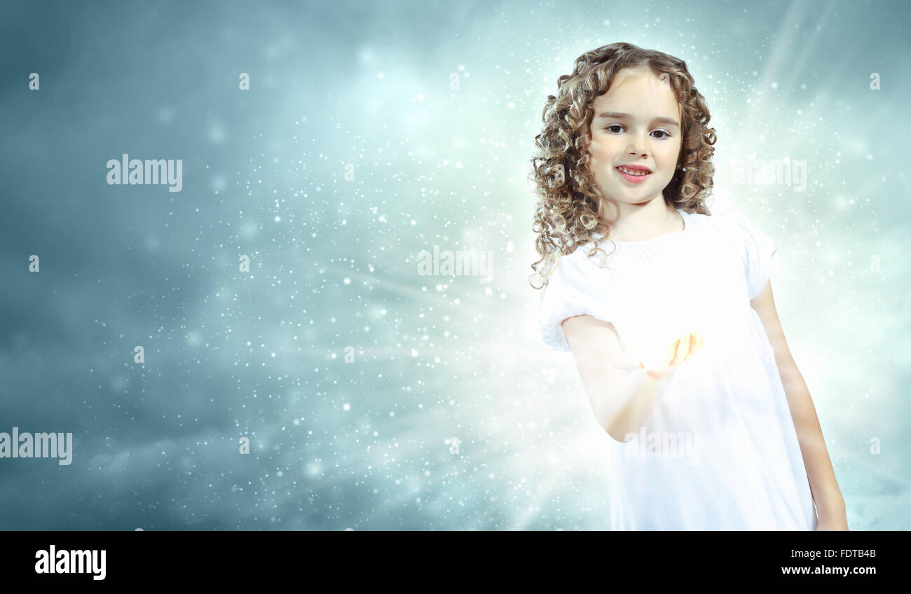 Little girl with magic lights and shining around Stock Photo - Alamy