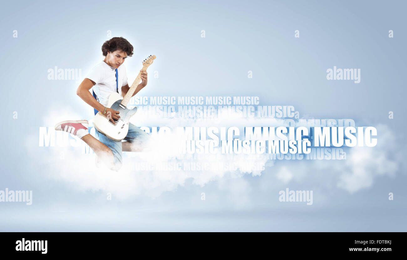 young man playing on electro guitar and jumping Stock Photo - Alamy