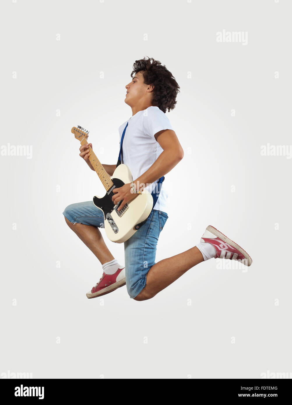 young man playing on electro guitar and jumping Stock Photo - Alamy