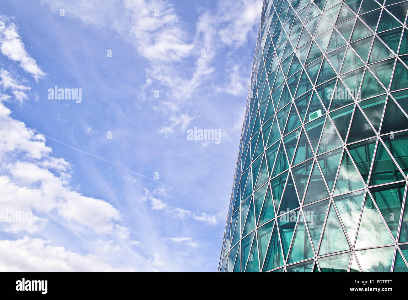 Glass front of building with blue cloudy sky Stock Photo - Alamy