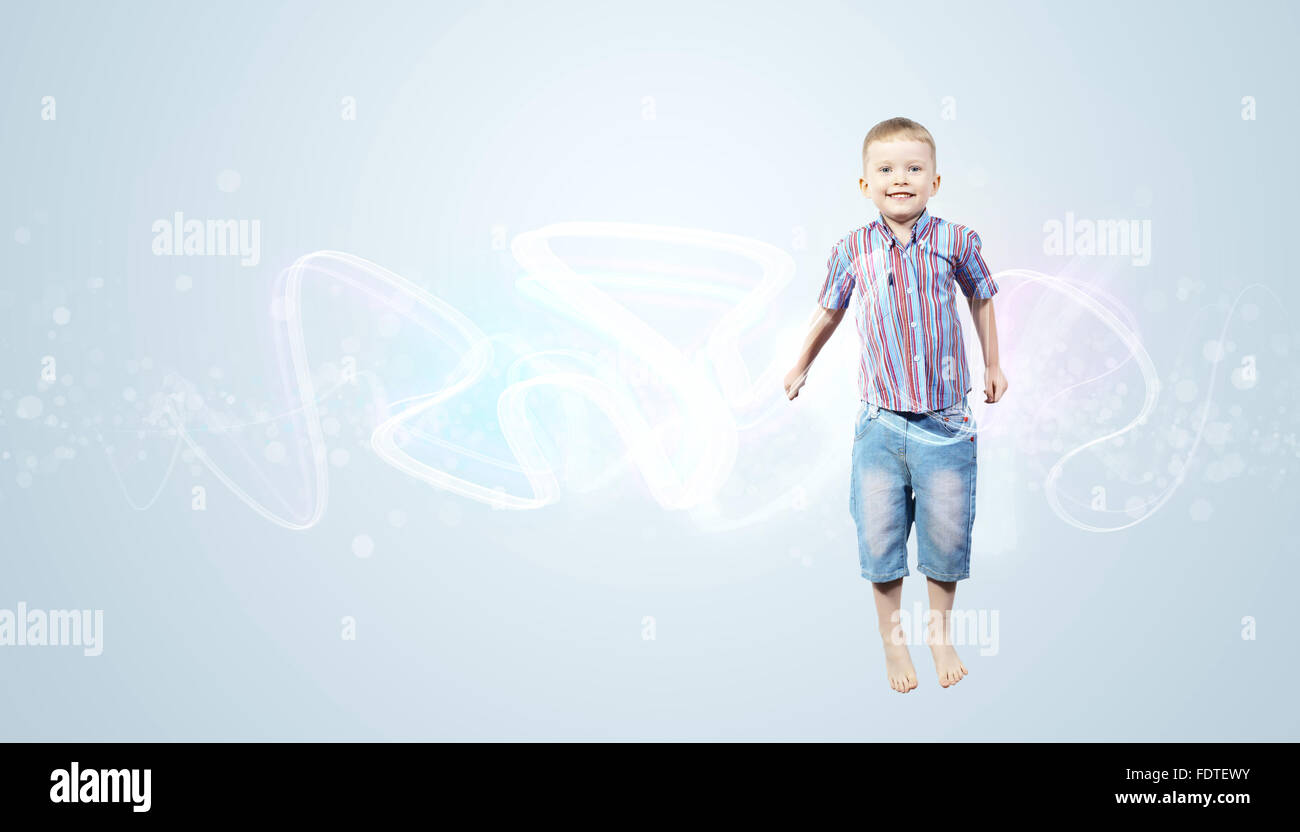 Photo of little boy jumping and raising hands Stock Photo - Alamy