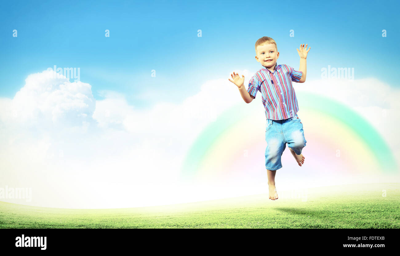 Photo of little boy jumping and raising hands Stock Photo - Alamy