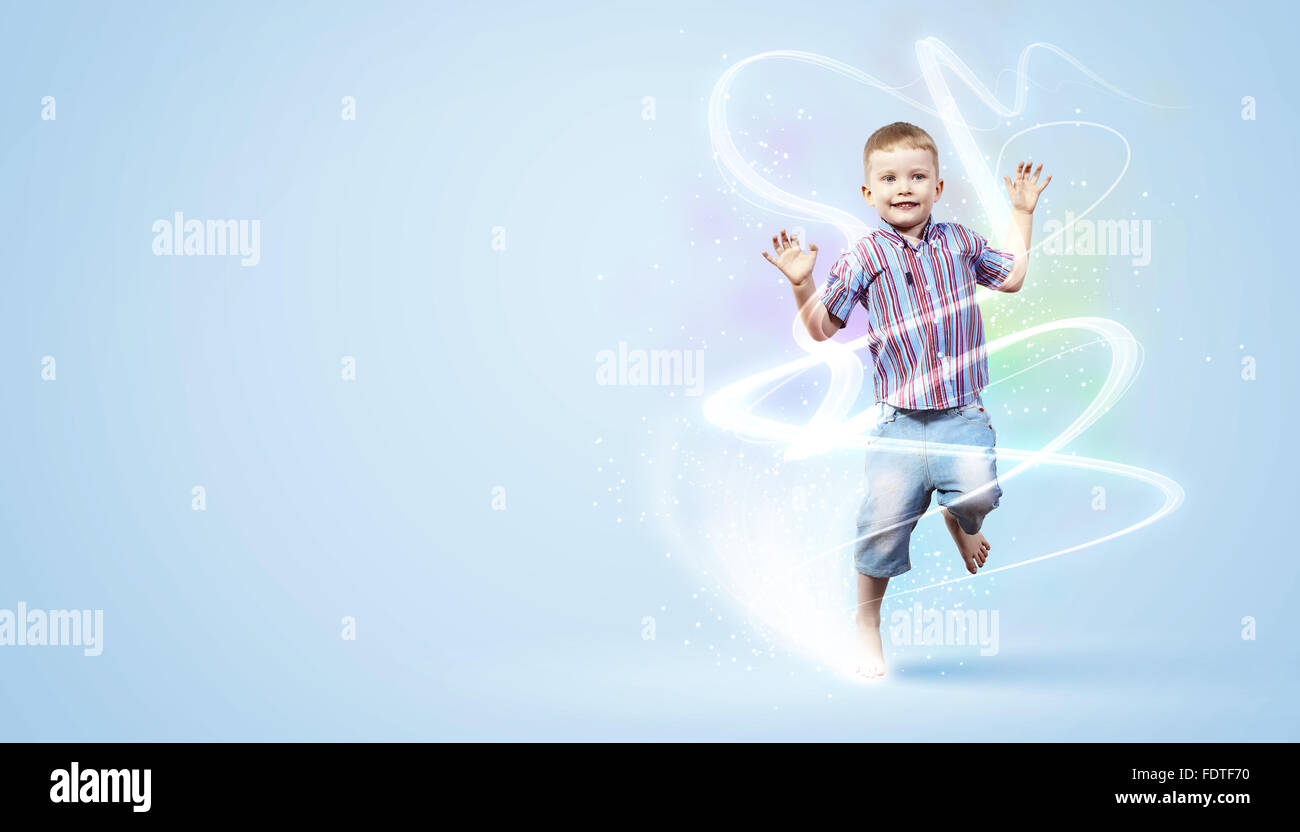 Photo of little boy jumping and raising hands Stock Photo - Alamy