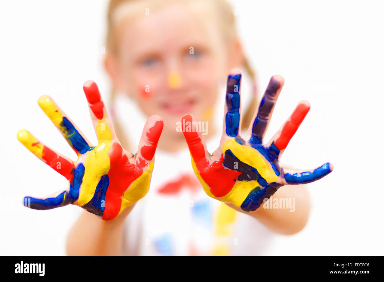 little child with hands painted in colorful paints ready for hand ...