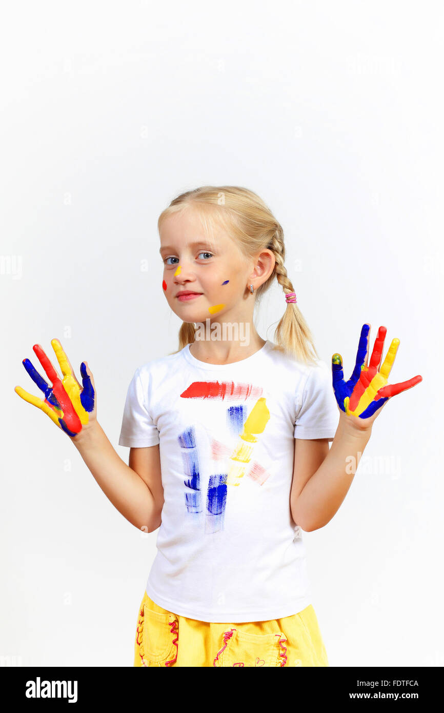little child with hands painted in colorful paints ready for hand ...